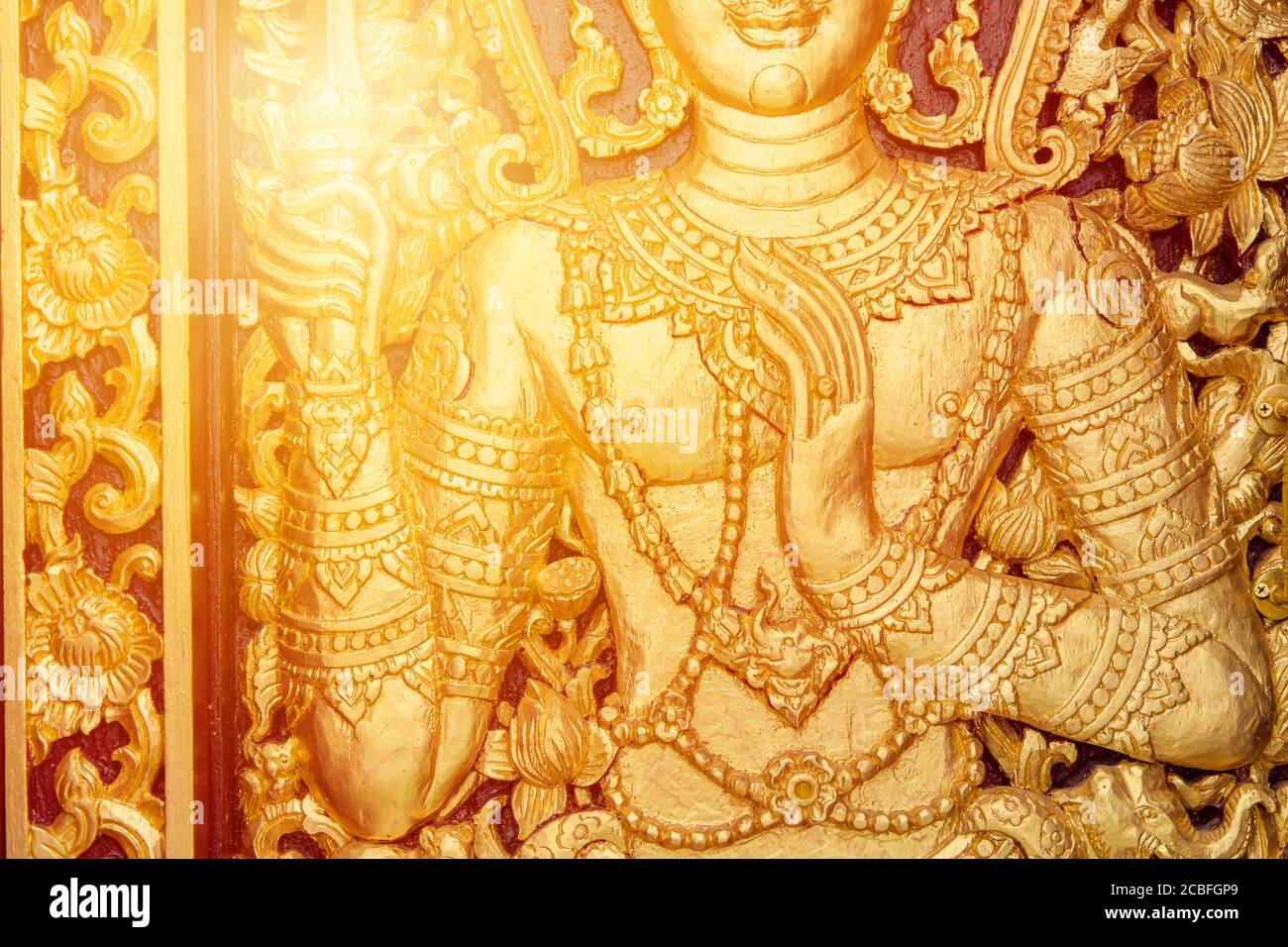 Thai woodcraft golden art god pattern at temple door Buddhist religion ...