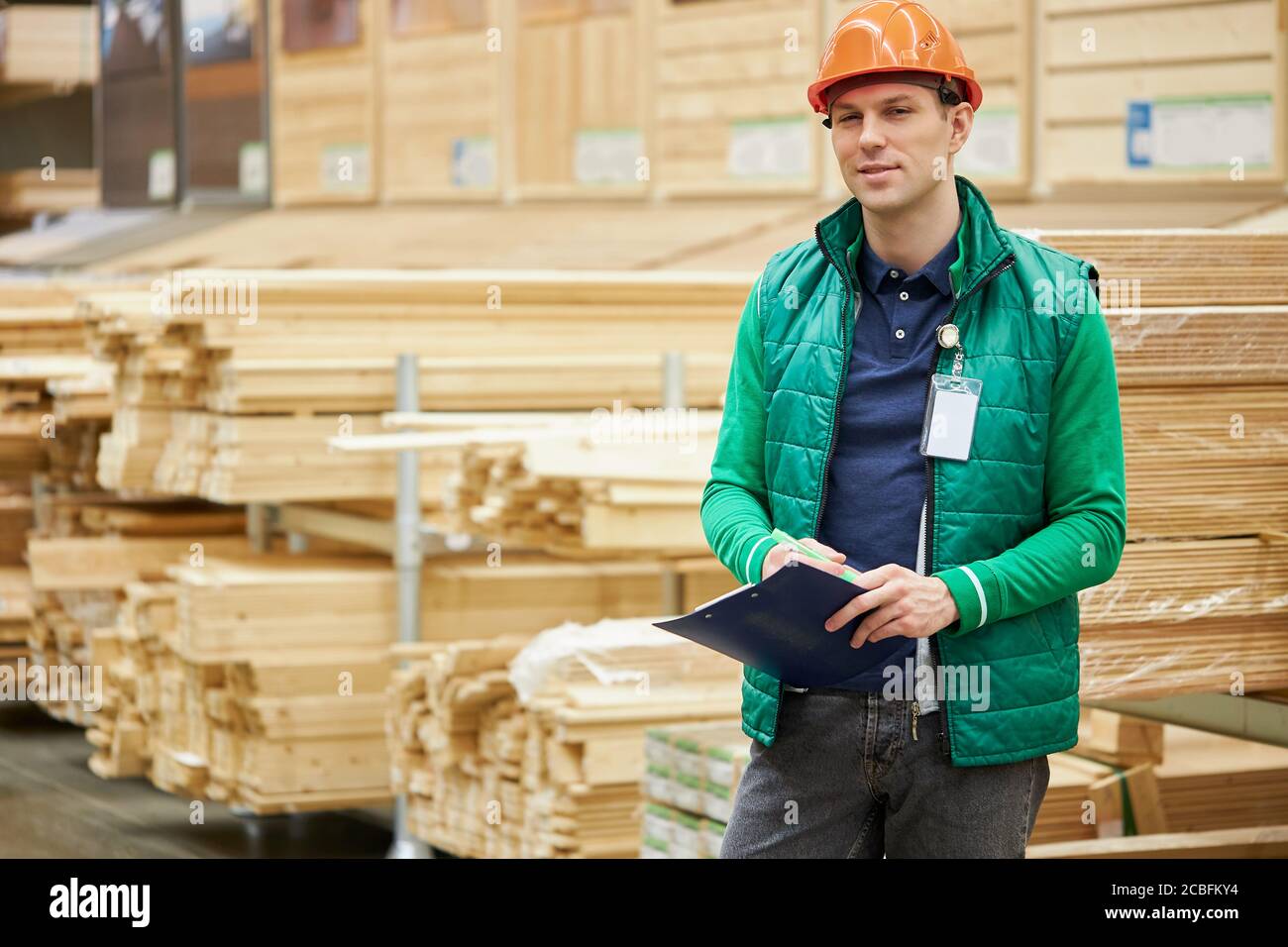 young hard working warehouse worker sorts commodity in factory, market ...