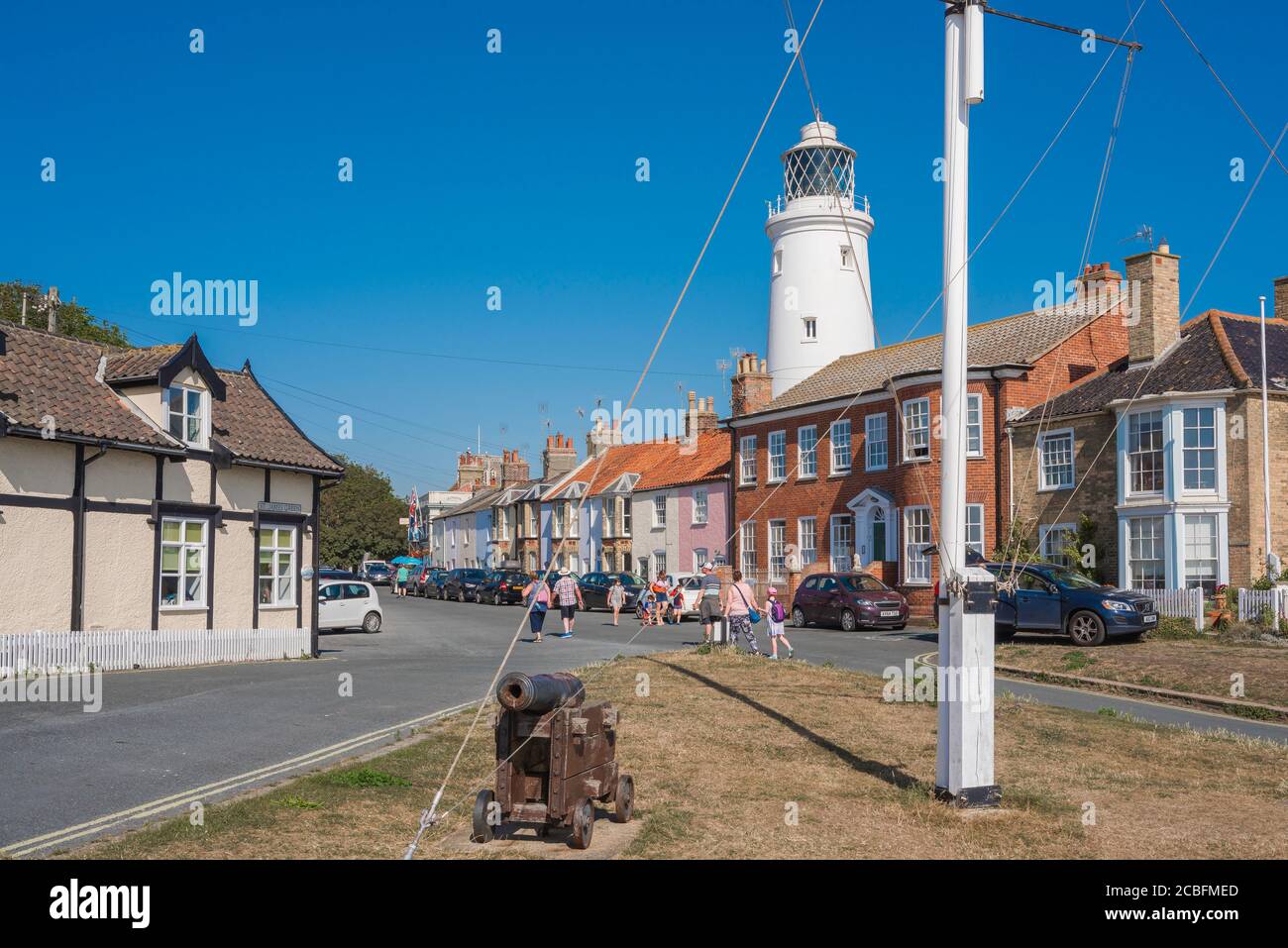 Suffolk coast, view in summer of people walking through St James Green ...