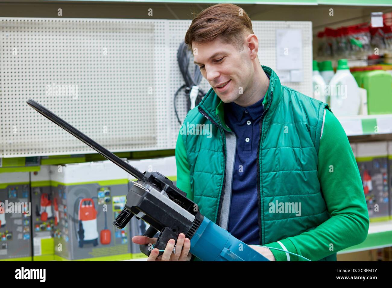smiling confident salesman try and check new commodity in store ...