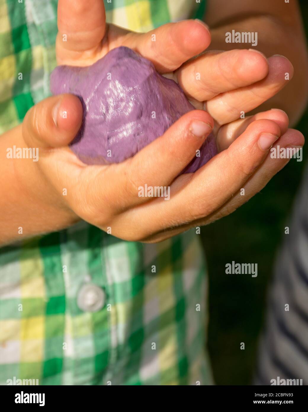 children's hands with self-made slime, slime making at a birthday party ...