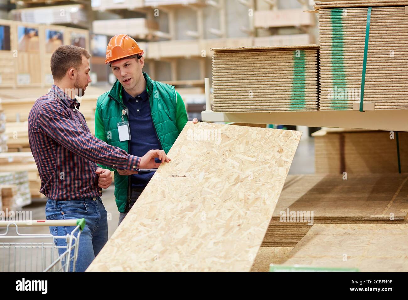 warehouse worker show the best variant of wooden board in their market ...