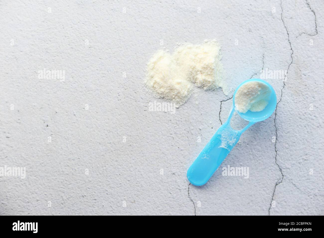 baby milk powder and spoon on white background Stock Photo - Alamy