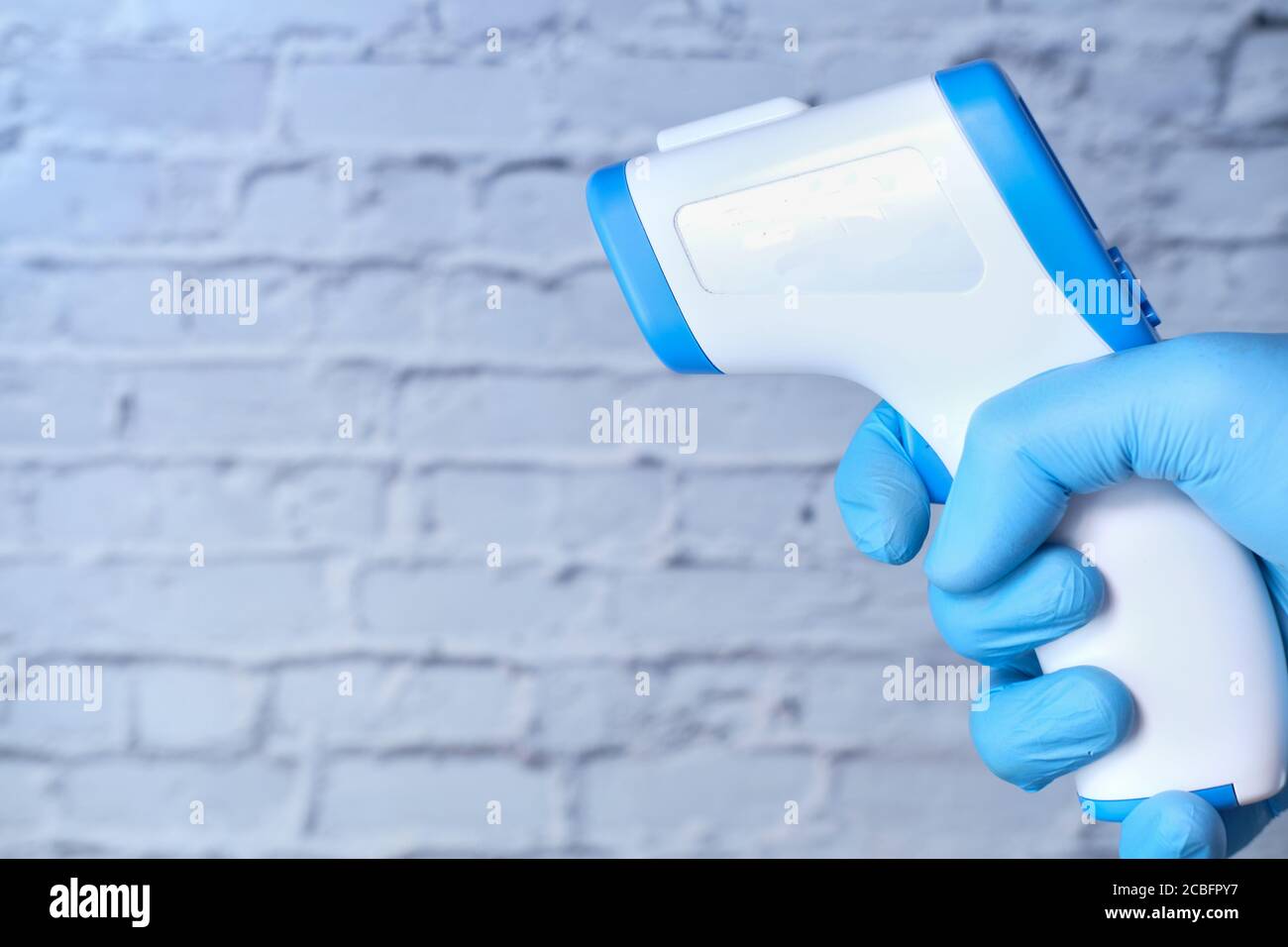 Hand holding infrared thermometer to measuring temperature Stock Photo ...