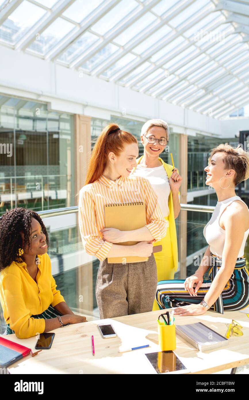 three happy girls greeting their new colleague with promotion, new job ...