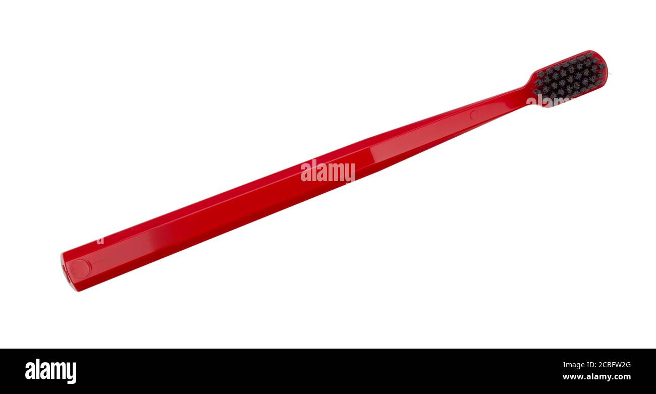 New red toothbrush with black hairs isolated on a white background ...