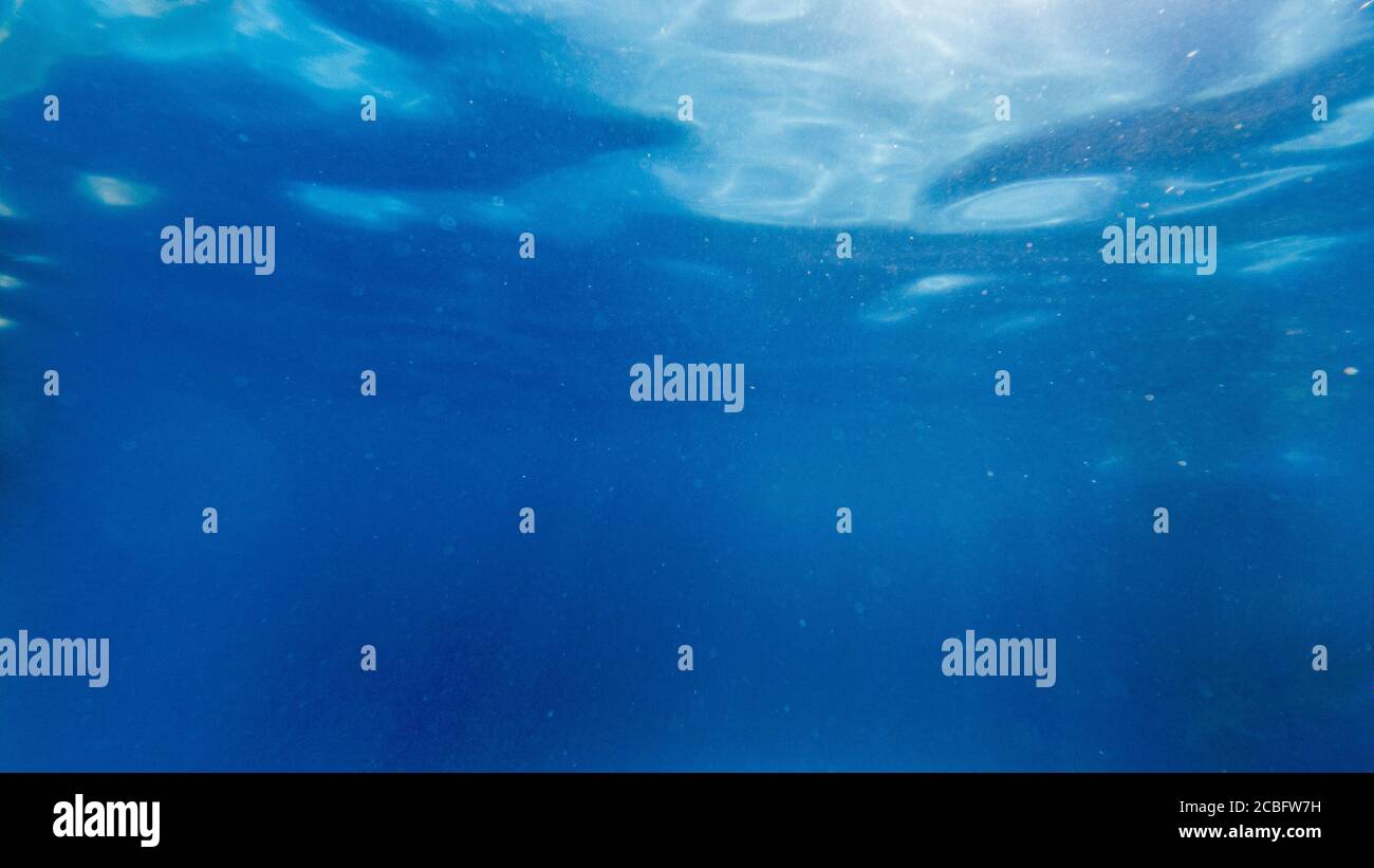 View from underwater with a calm surface and deep darkness Stock Photo ...