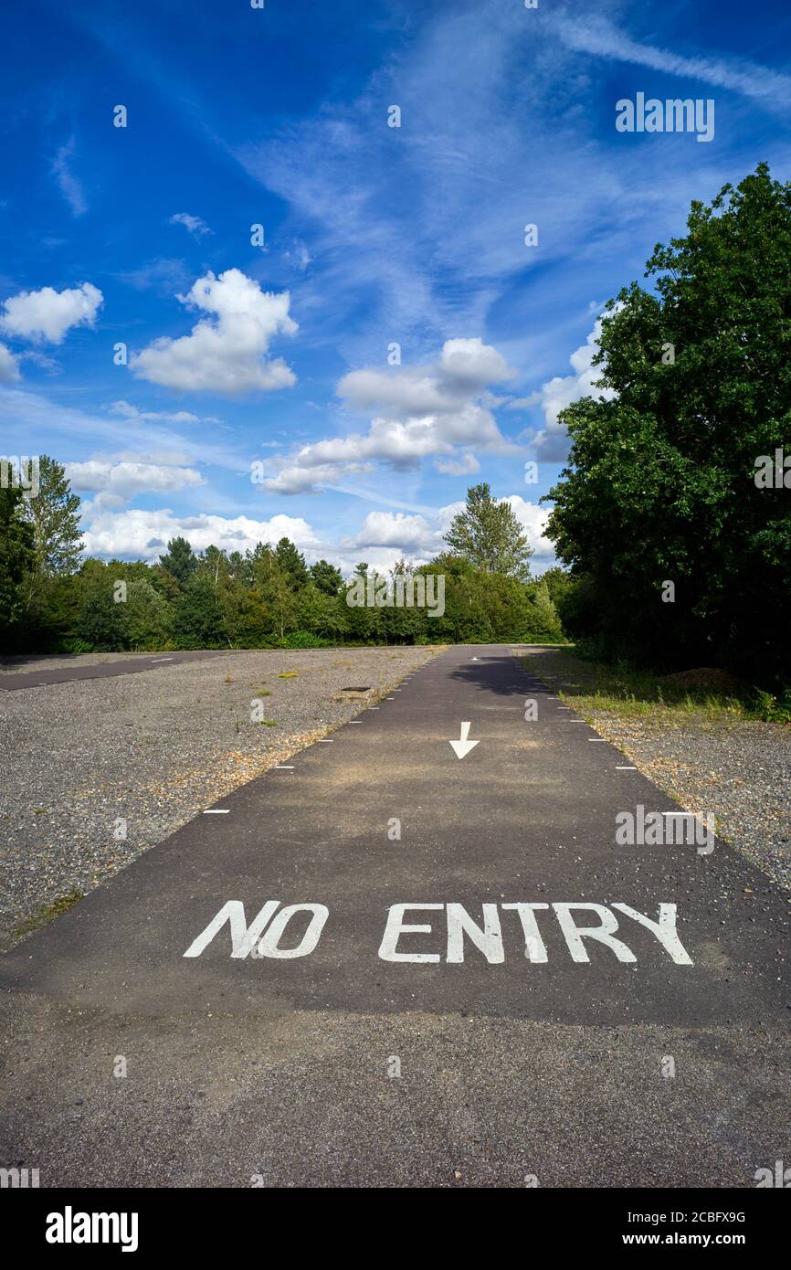 A completely empty car park with a no entry sign painted on the tarmac ...