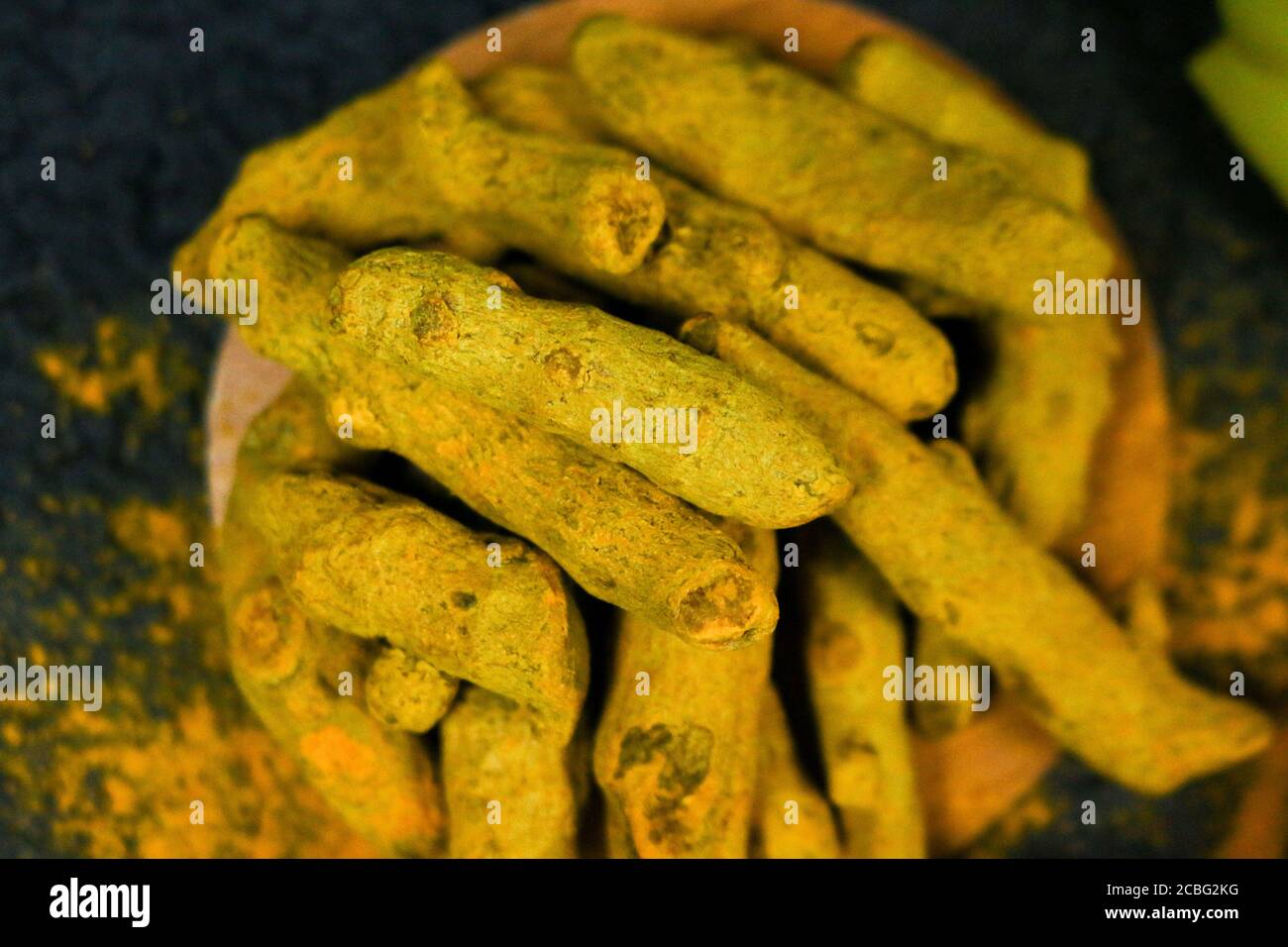 Turmeric, (Curcuma longa) with yellow flowers isolated on black ...