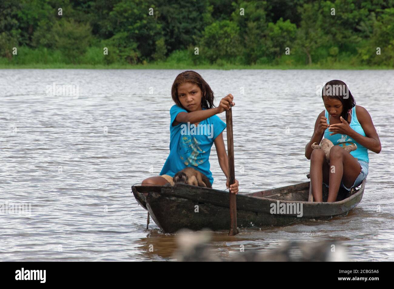 Manaus, indigenous girls in a canoe on the Amazon River Stock Photo - Alamy