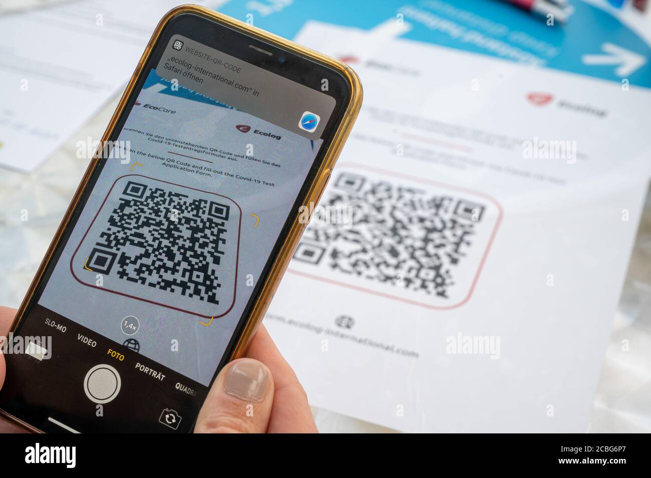Munich, Germany. 13th Aug, 2020. A woman scans a digital QR code with ...