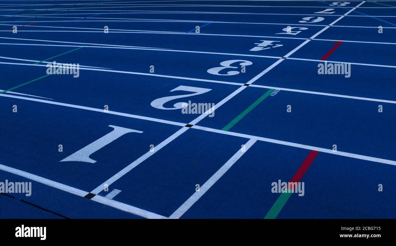 Blue Running Track with White Lane Numbers in Outdoor Stadium Stock ...