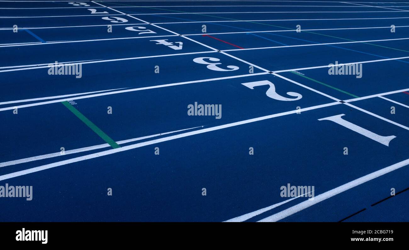 Blue Running Track with White Lane Numbers in Outdoor Stadium Stock ...