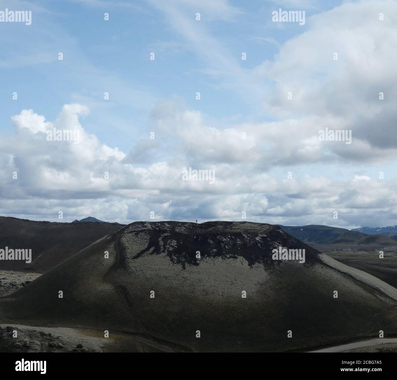 Lone Hiker Walks at the Edge of a Volcano Stock Photo - Alamy