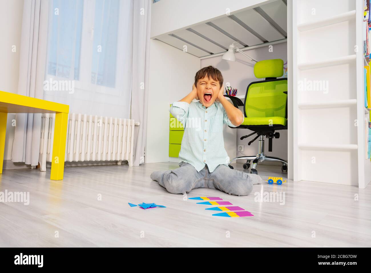 Autistic boy with educational exercise development geometric shapes ...