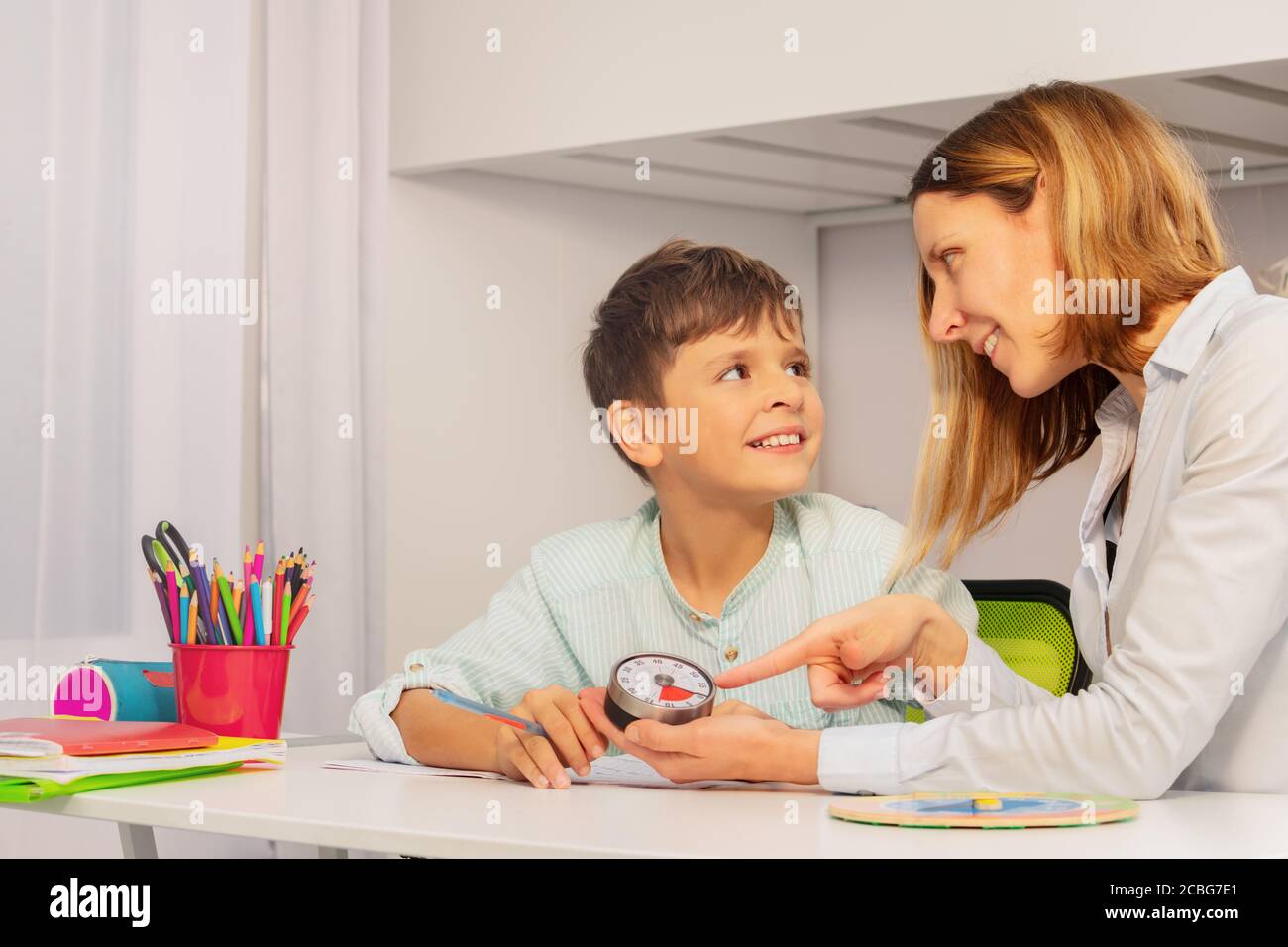 Boy with autism spectrum disorder during ABA therapy look at teacher ...