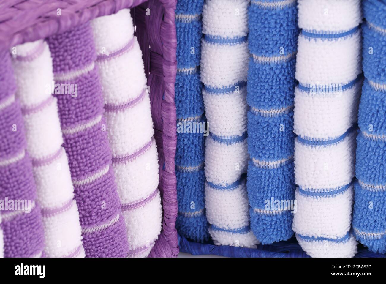 Pink, blue and white folded towels in boxes closeup picture Stock Photo ...