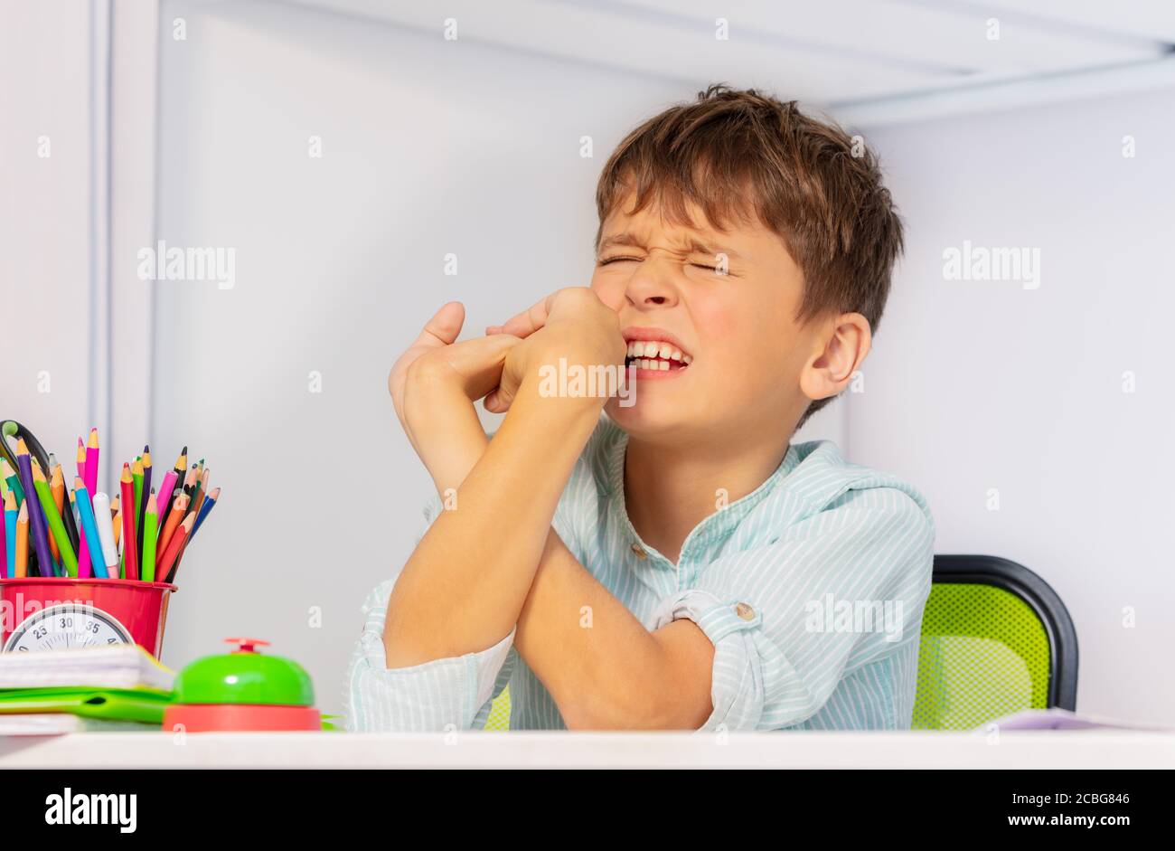 Sad boy with autistic disorder breaking hands and fingers in negative ...