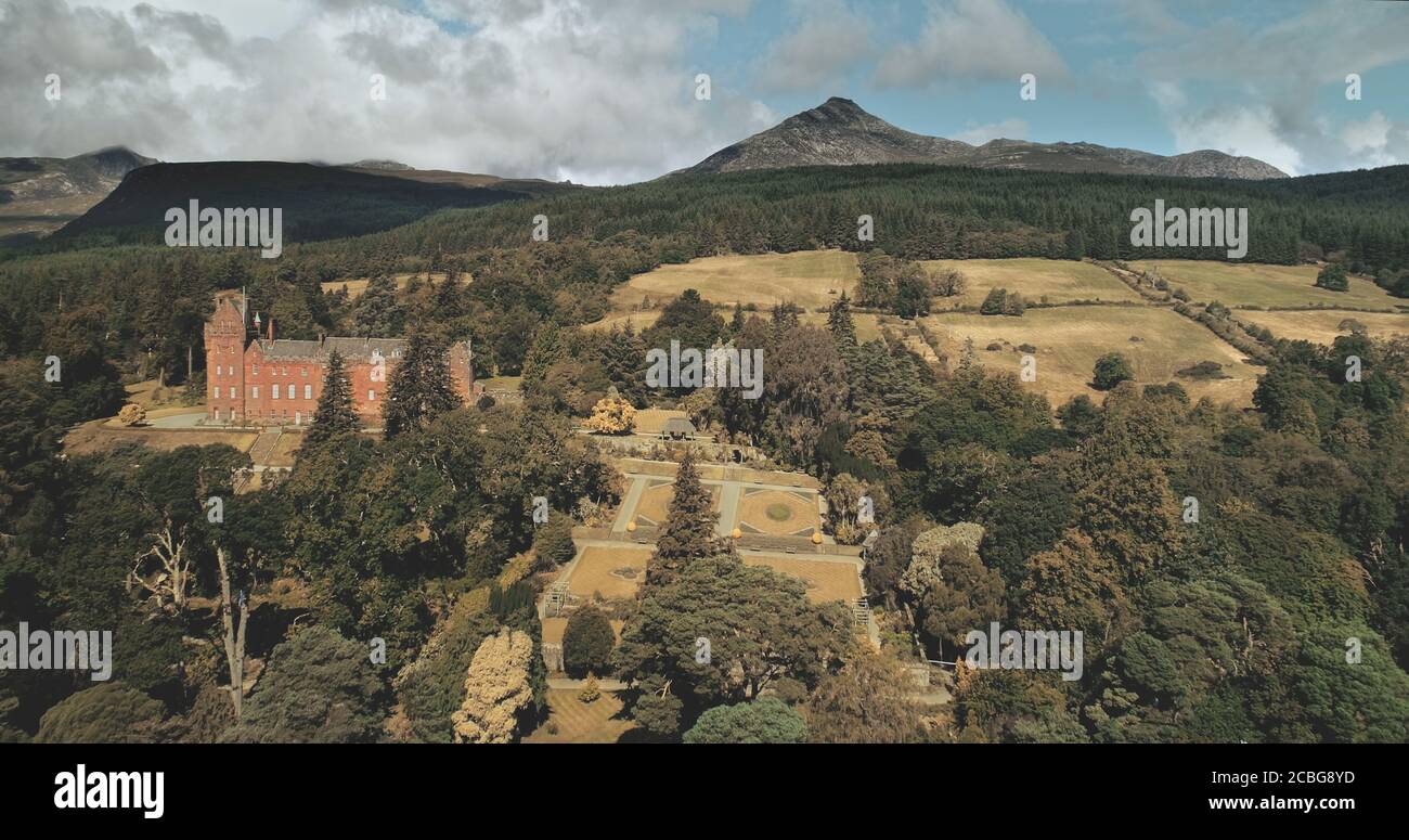 Scotland's ocean landscape shore aerial shot: trees and road with cars ...
