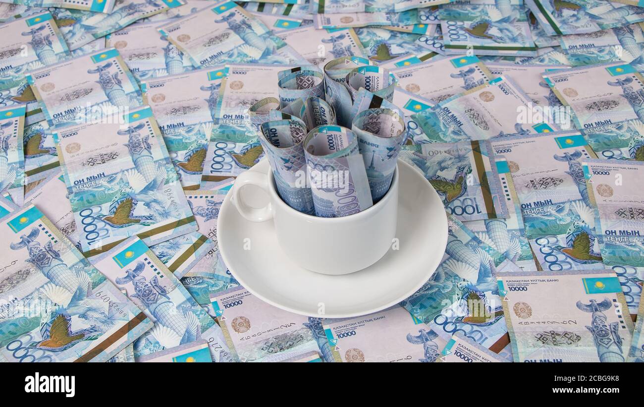 Money in a Cup of coffee. Tenge, the national currency of Kazakhstan ...