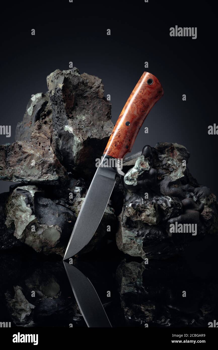 Hunter knife and broken stones. The blade has a beautiful damask ...