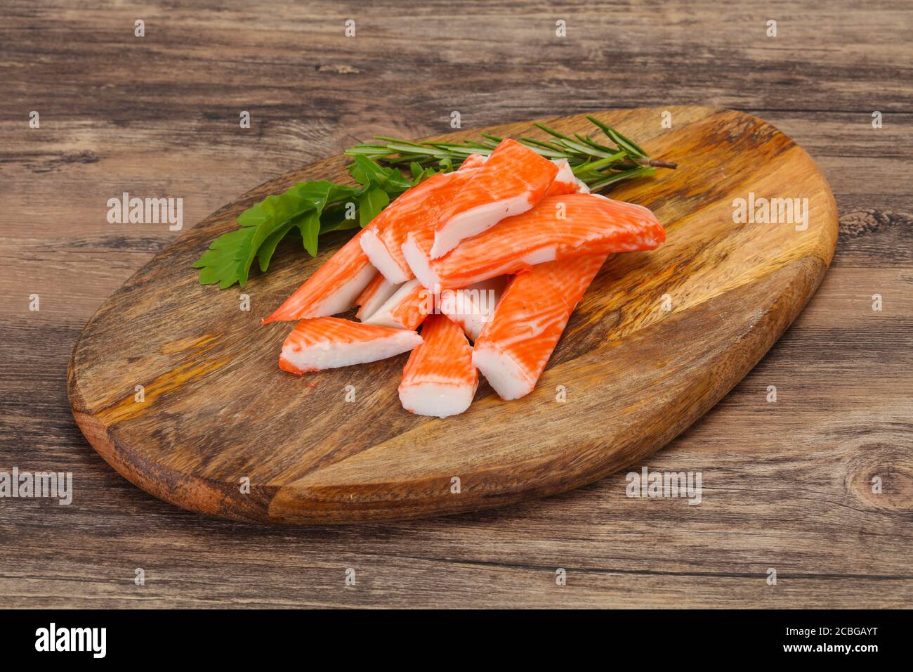 Crab stick surimi over wooden board Stock Photo - Alamy