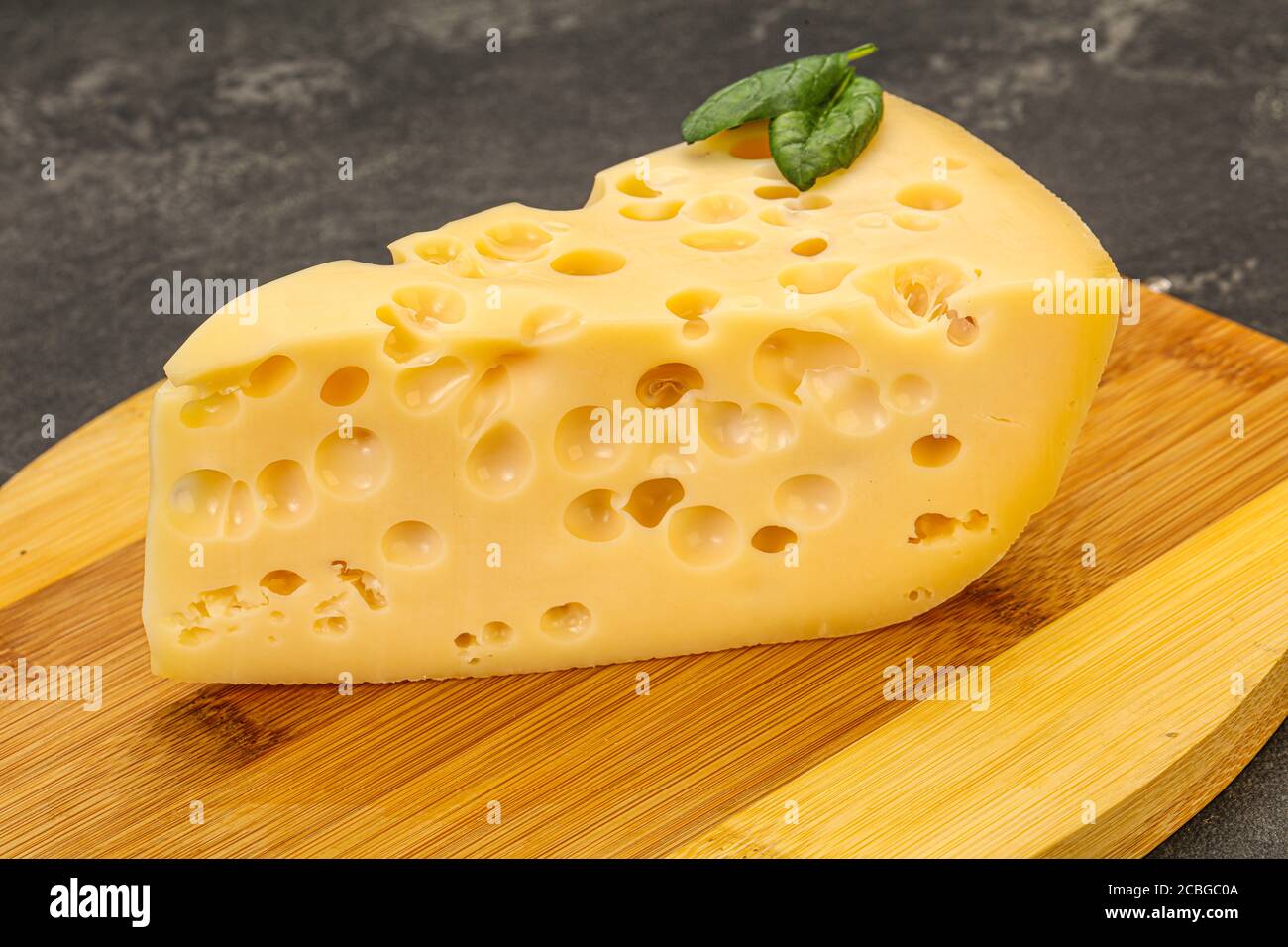 Maasdam cheese - dairy yellow triangle with holes Stock Photo - Alamy