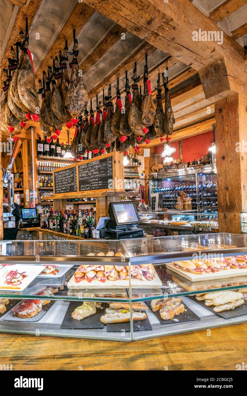 Spanish hams hang from the ceiling inside a bar in Burgos, Castile and ...