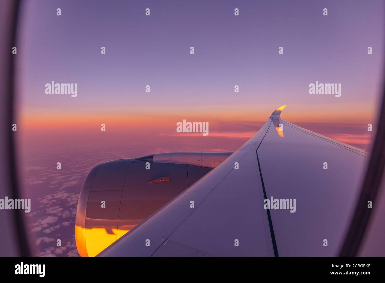 Beautiful scenic city view of sunset through the aircraft window ...