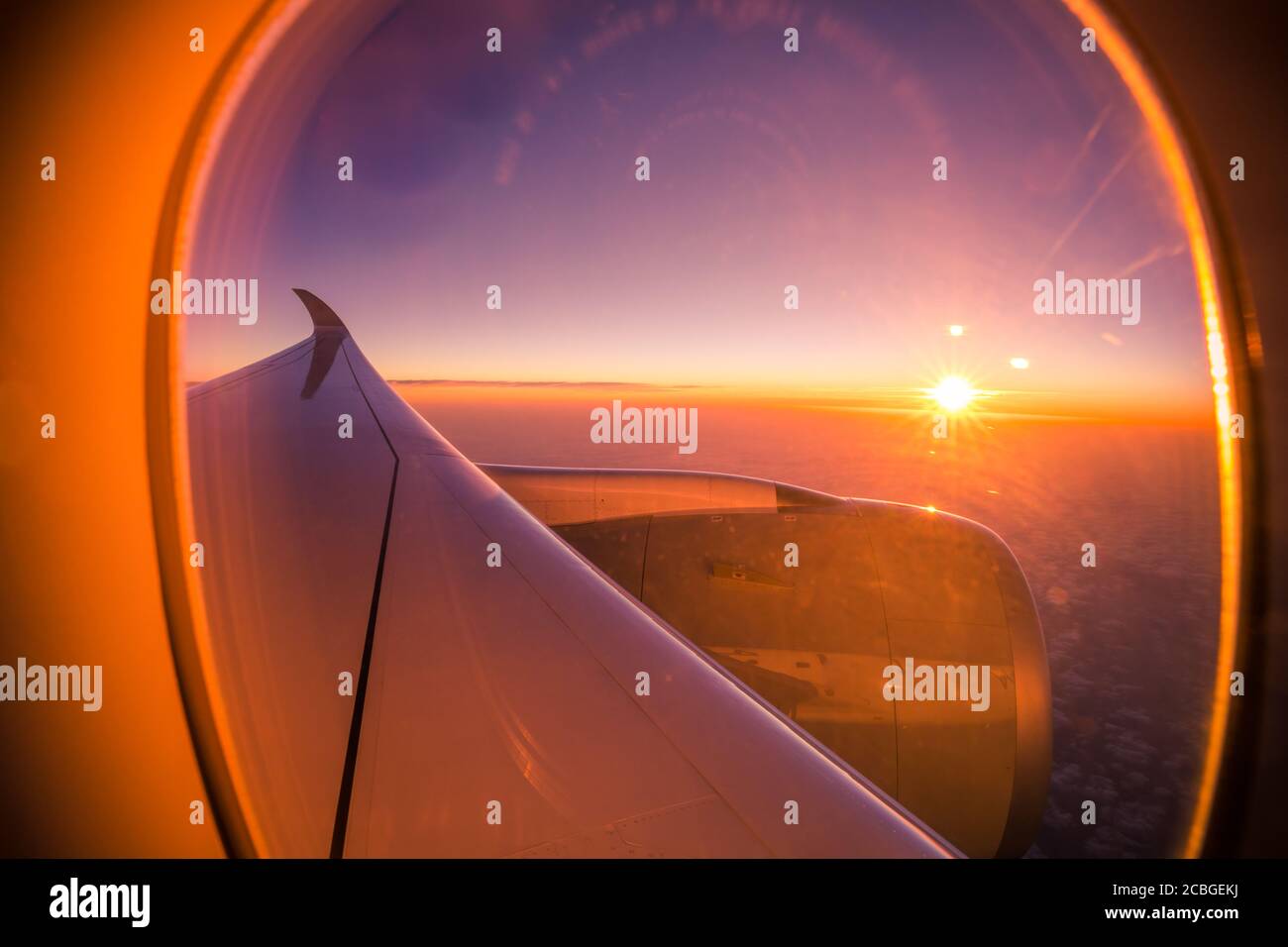 Beautiful scenic city view of sunset through the aircraft window ...