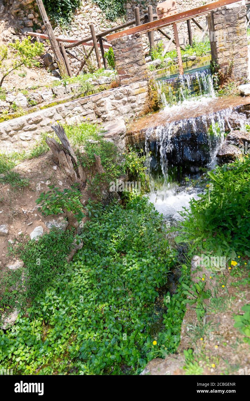 Piccolo makes water and forms a small waterfall on a sunny day Stock ...