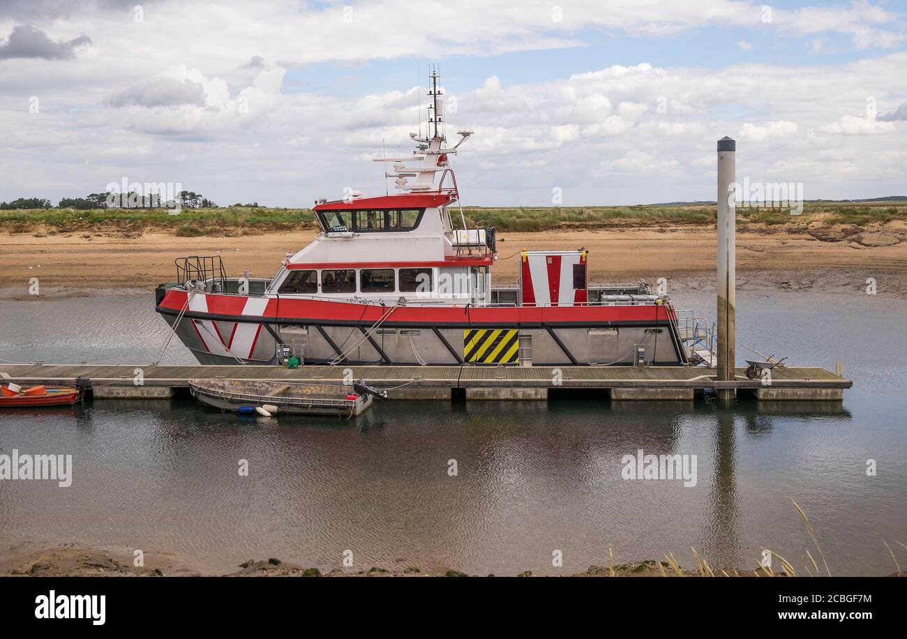 Coastal work boat moored to a floating jetty Stock Photo - Alamy
