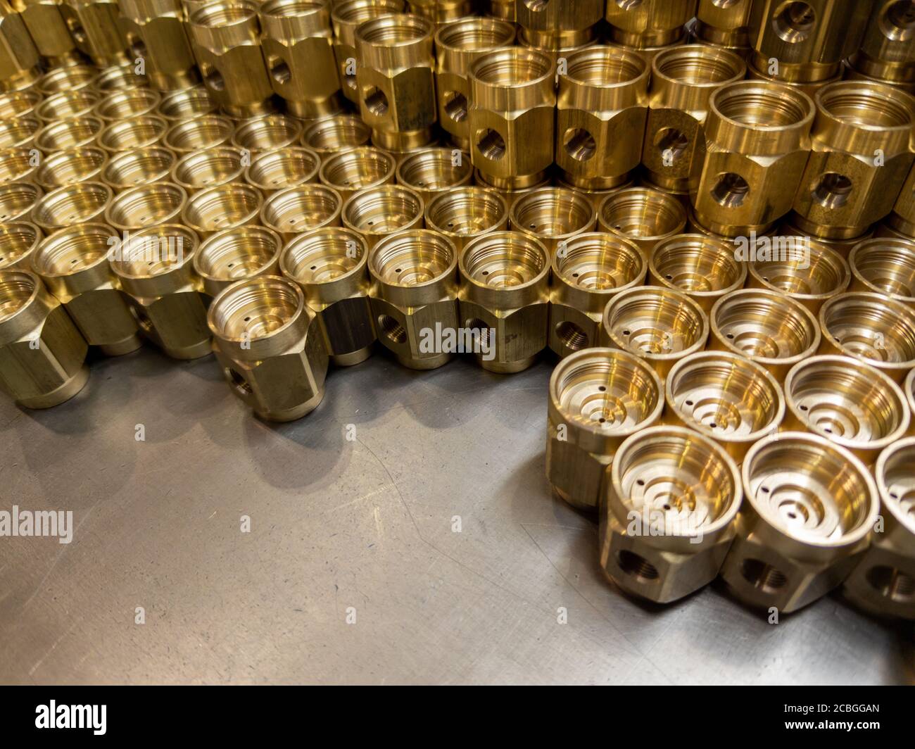 Shiny yellow metal parts background. Shiny brass metal threaded ...