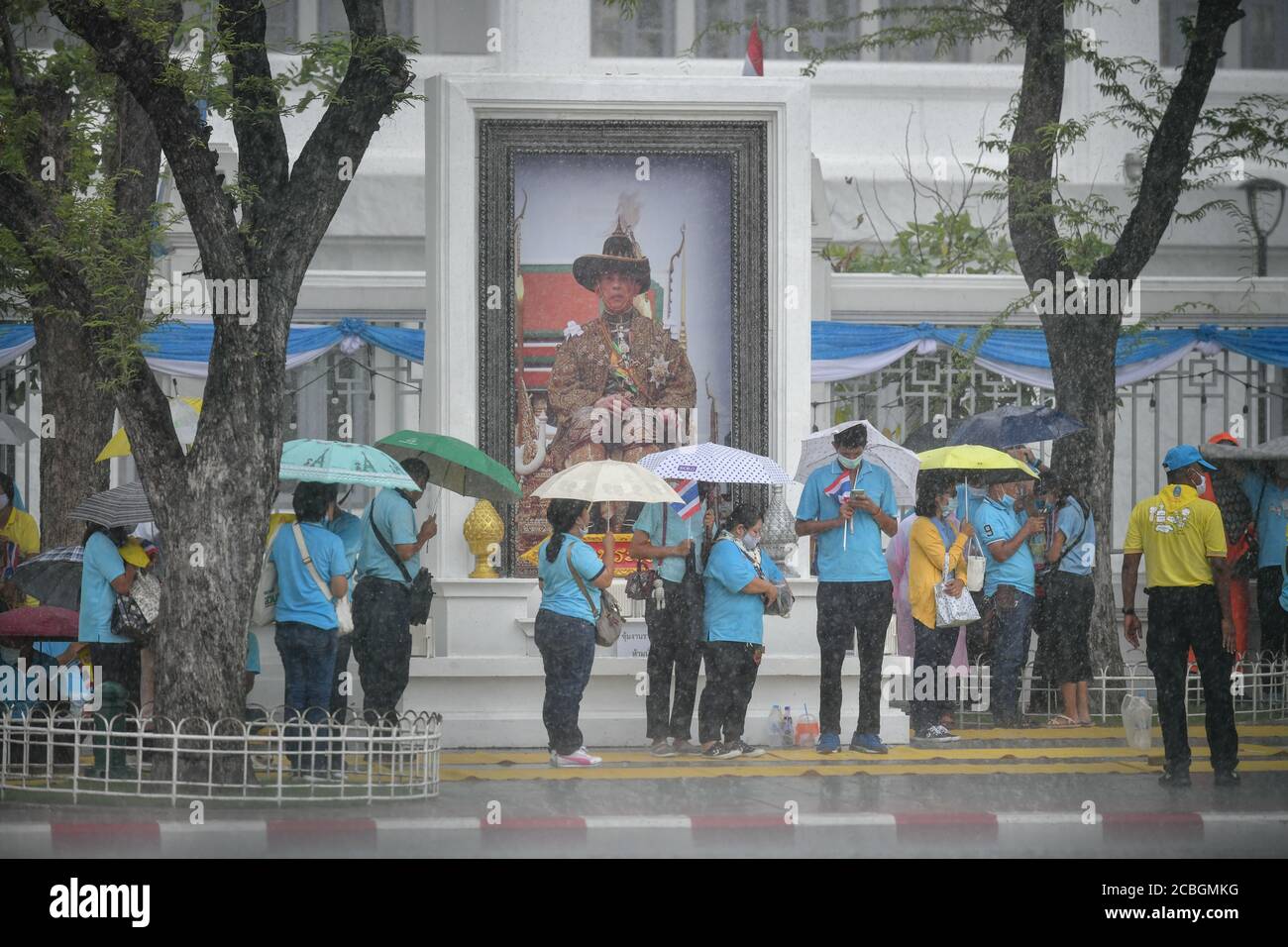 Thai well-wishers gather at the Grand Palace wall as they attend the ...