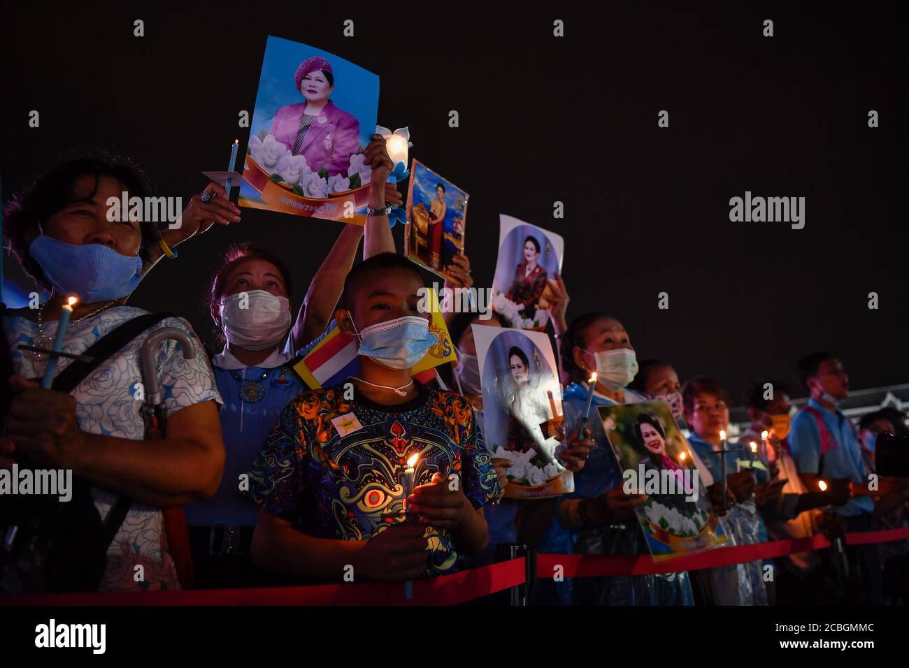Thai well-wishers hold pictures of Thai Queen Sirikit as they attend ...