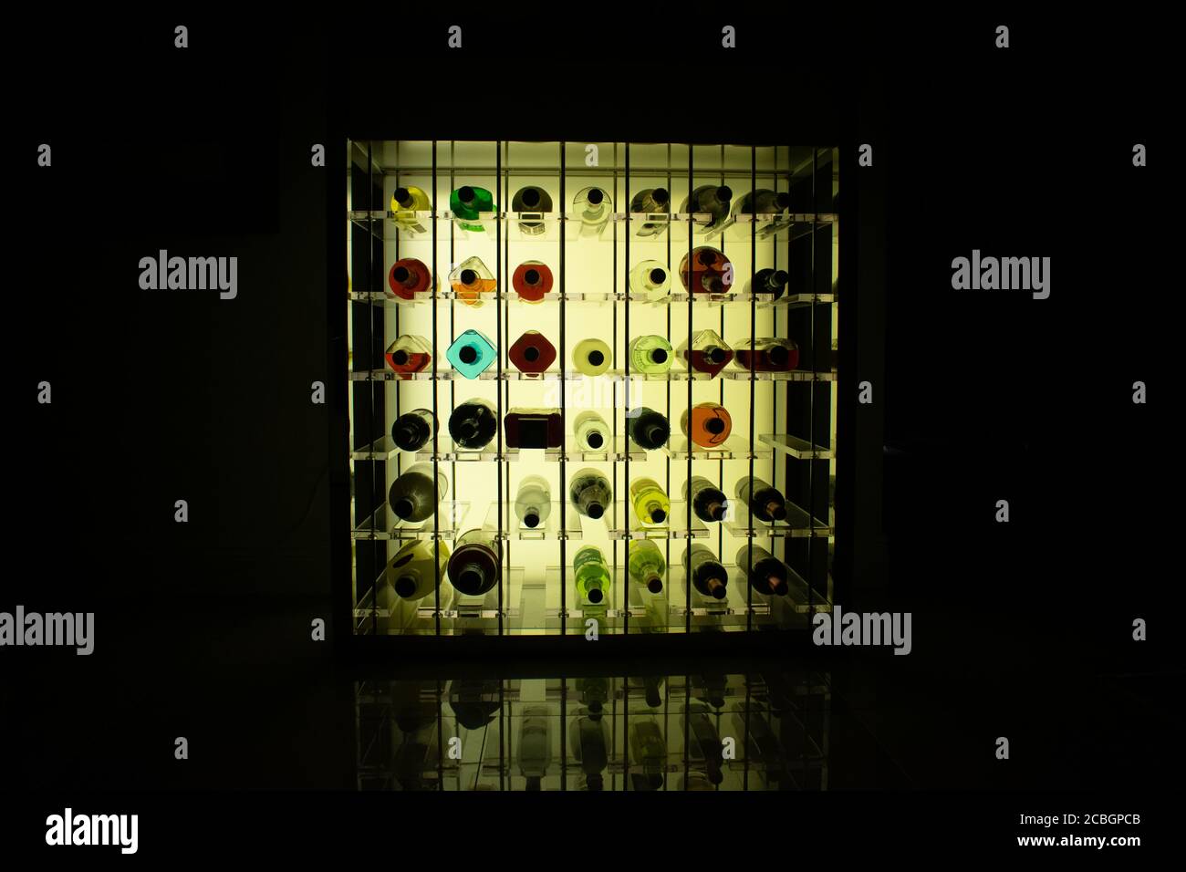 A Yellow Backlit Rack of Bottles of Wine Stock Photo - Alamy
