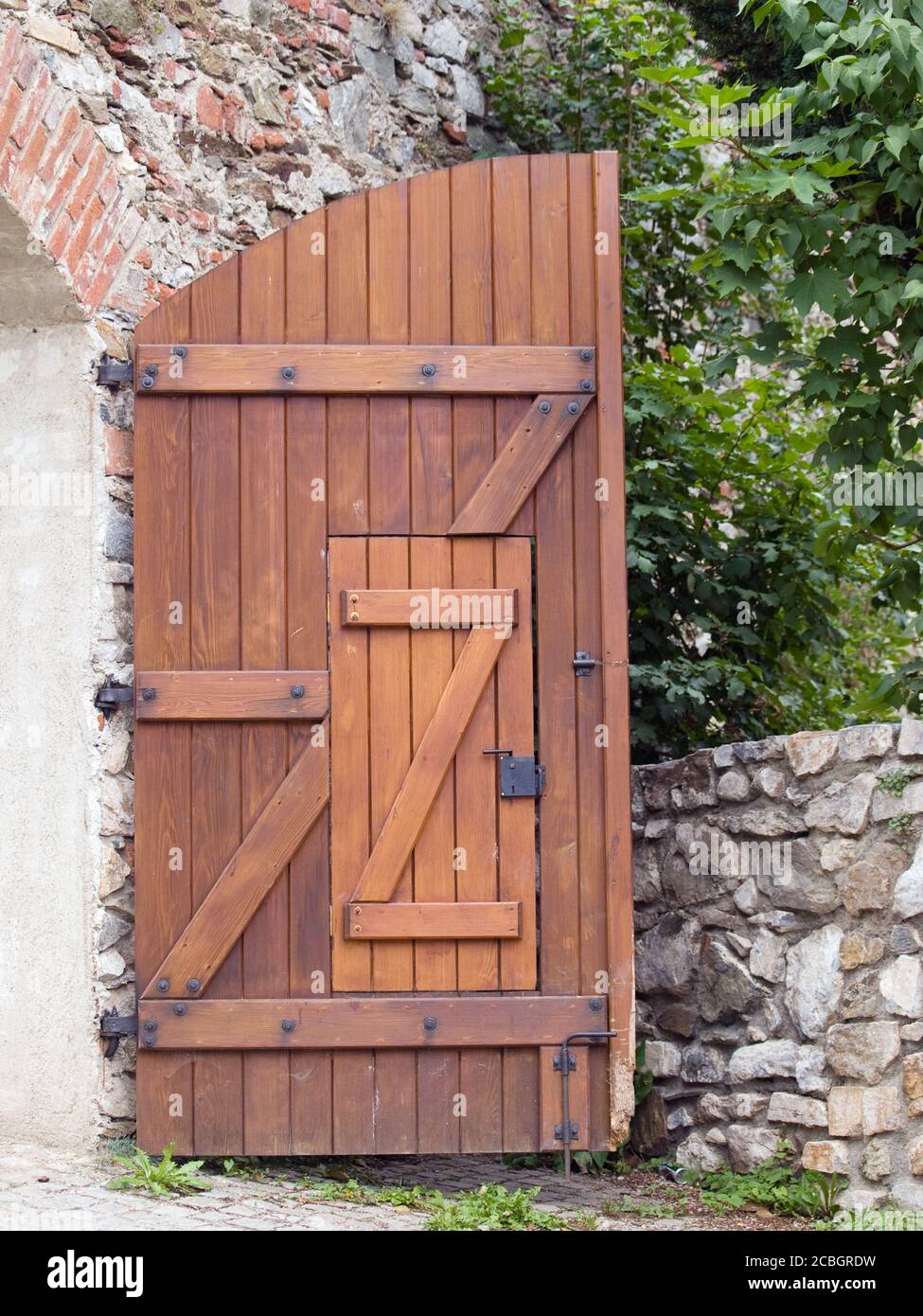 Half of open wooden gate with wicket Stock Photo - Alamy