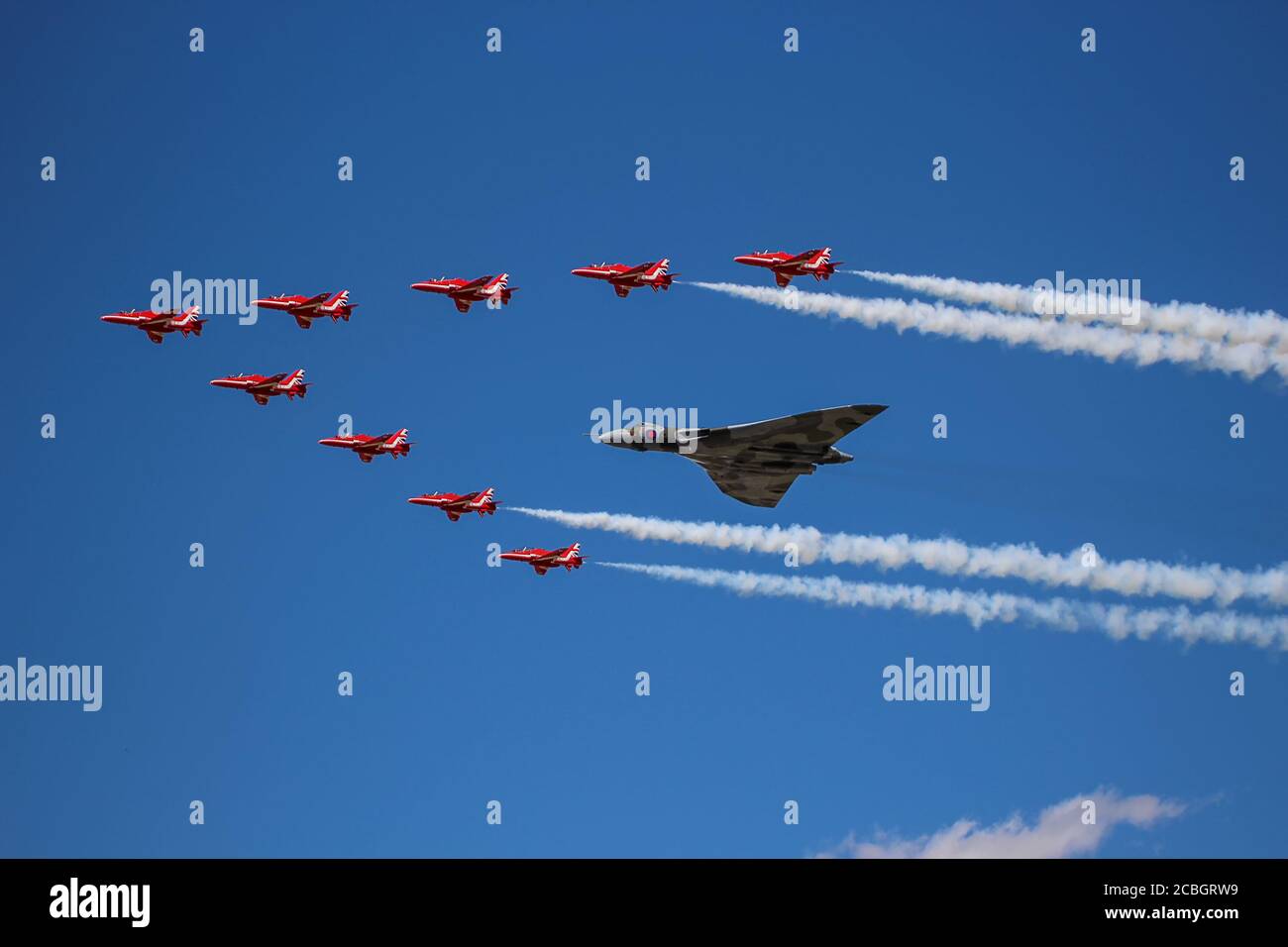 The Avro Vulcan XH558 being escorted by the Red Arrows Stock Photo - Alamy