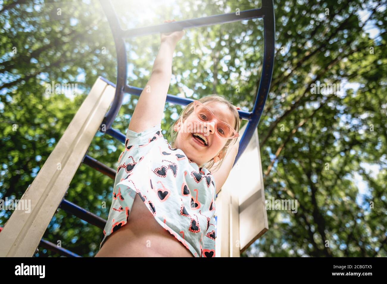 Female child hanging upside down hi-res stock photography and images - Alamy