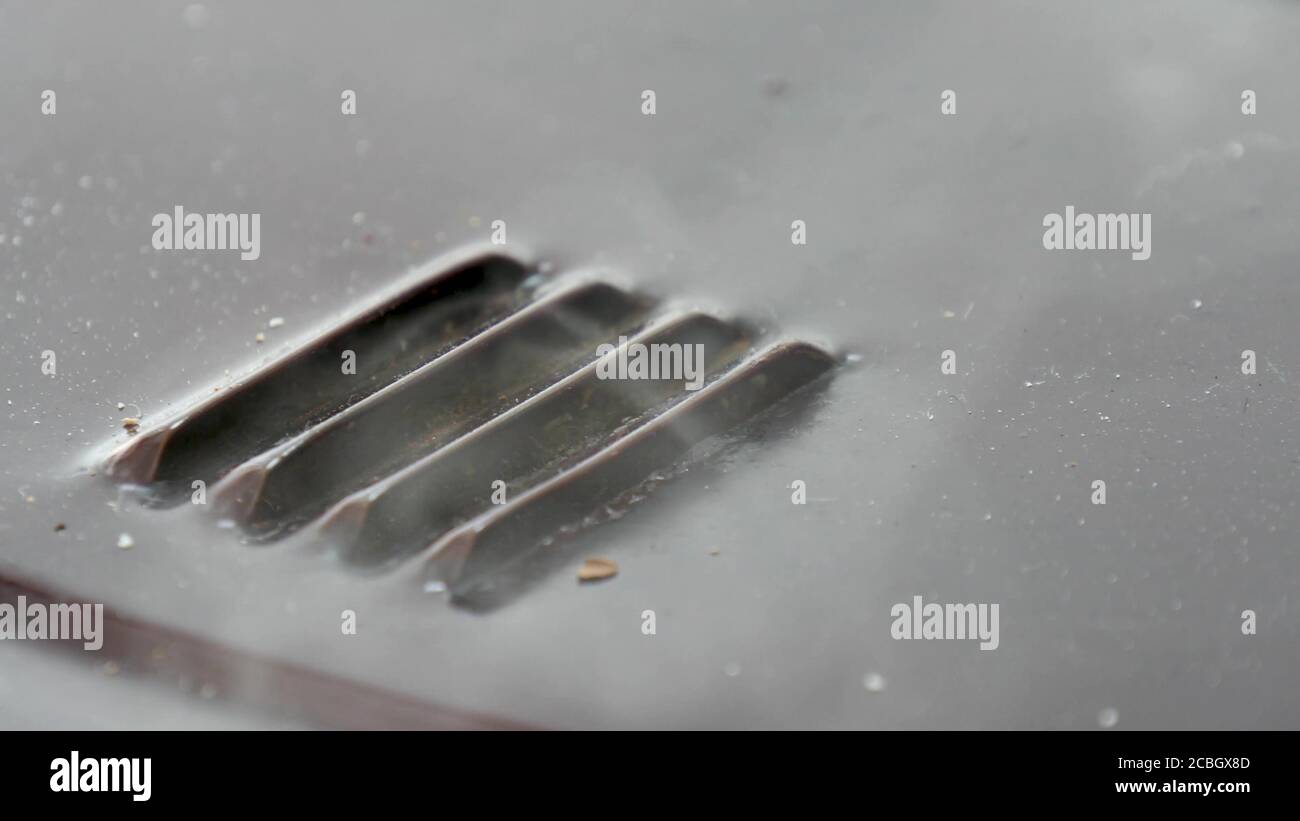 Vent hole with steam on the sheet metal Closeup view Stock Photo - Alamy