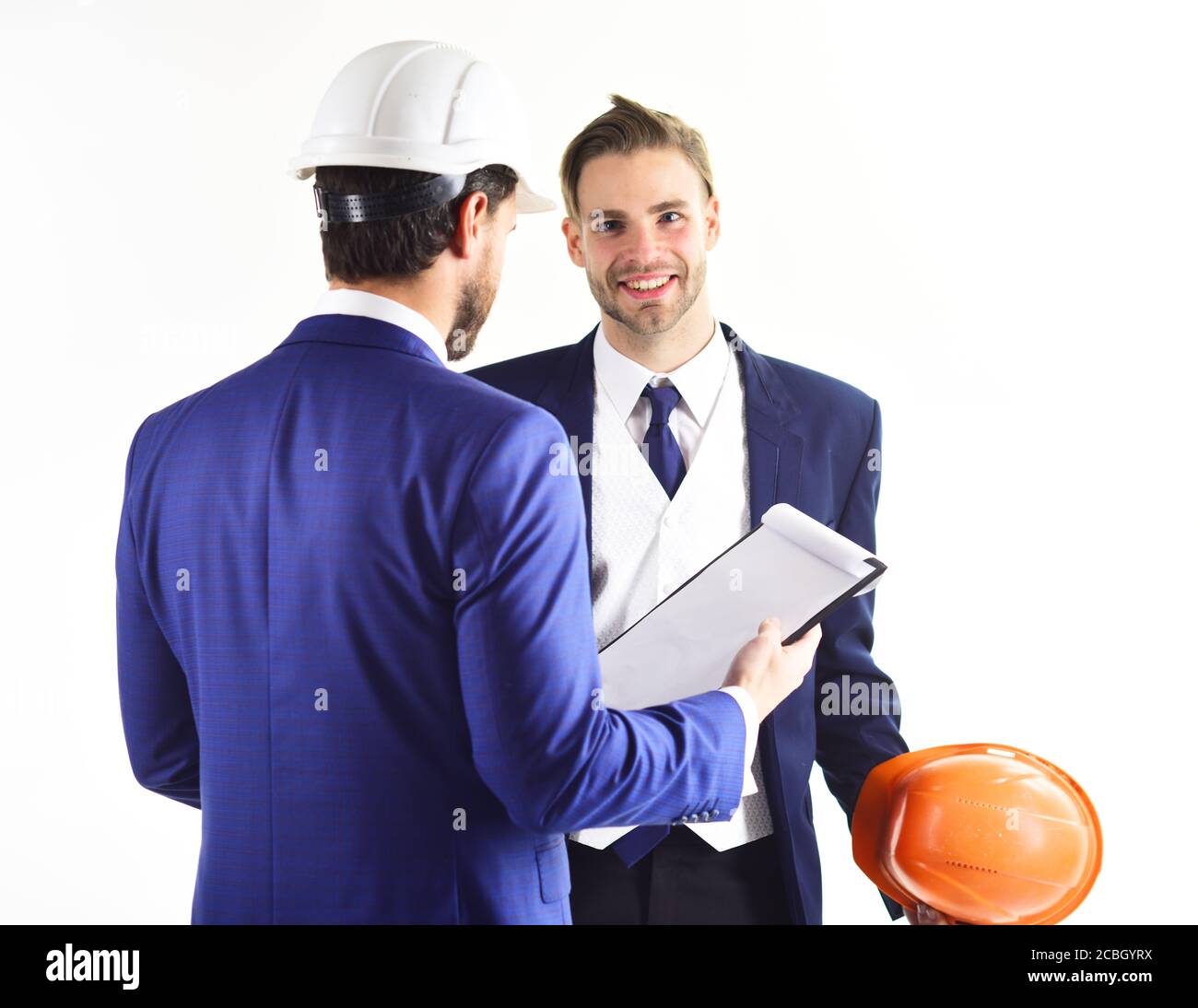 Entrepreneur and engineer with plans and smartphone. Construction ...