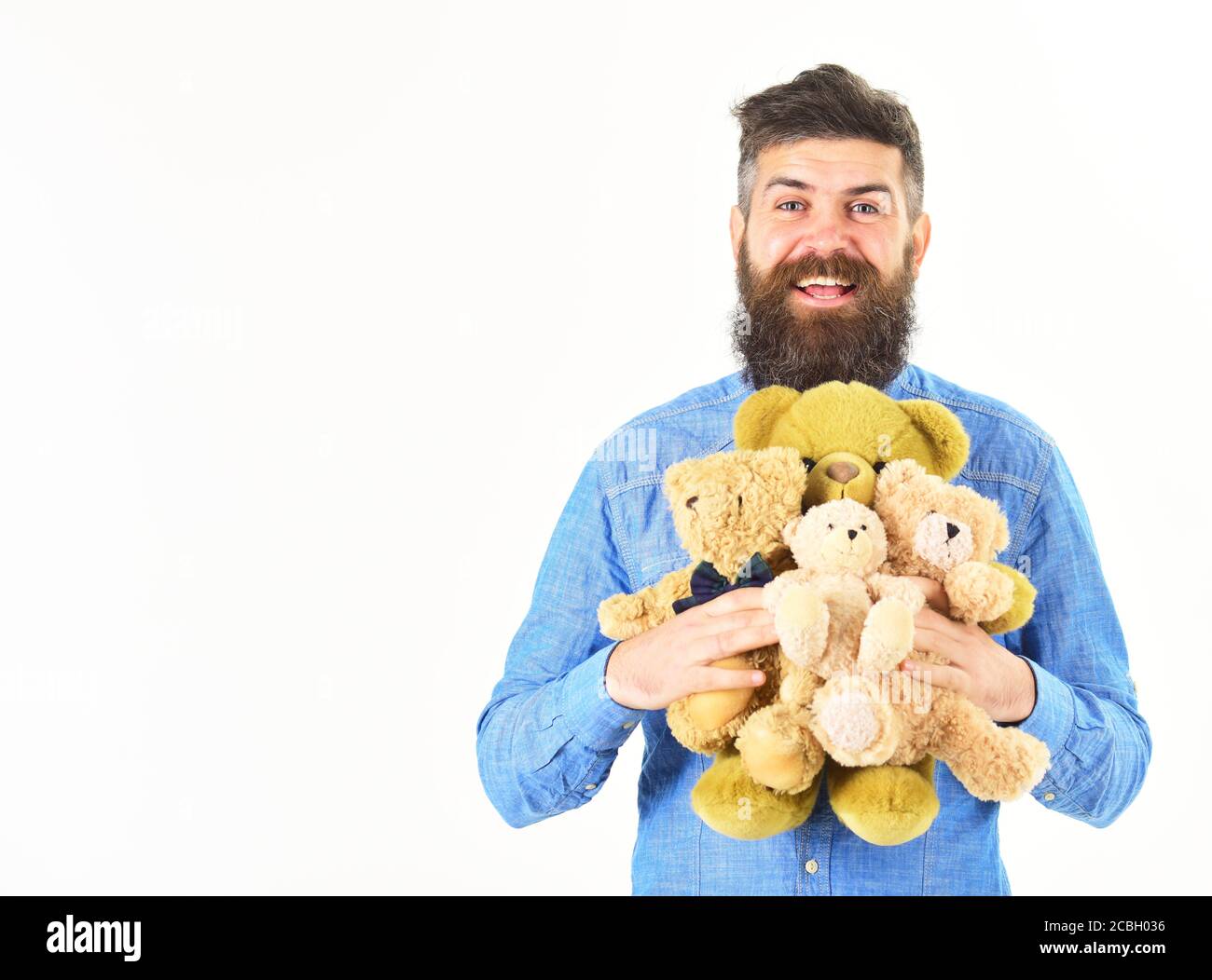 Guy with beard hugs soft toys with tenderness. Man with happy face ...