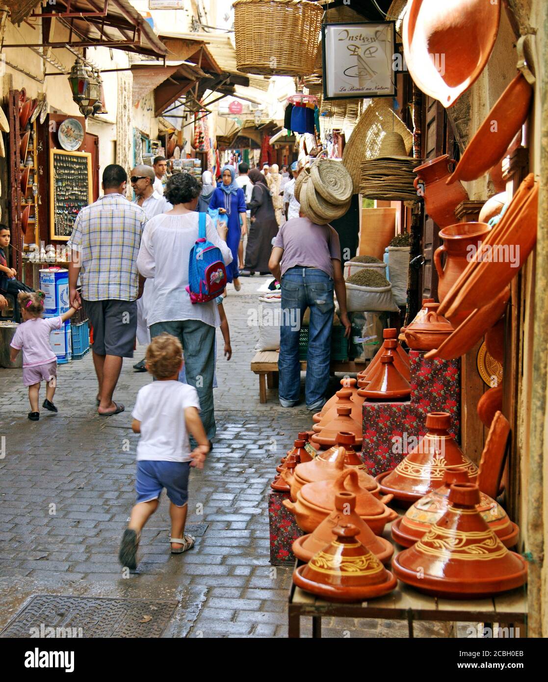 A family walks through the Fez Old medina with children in-tow in Fez ...