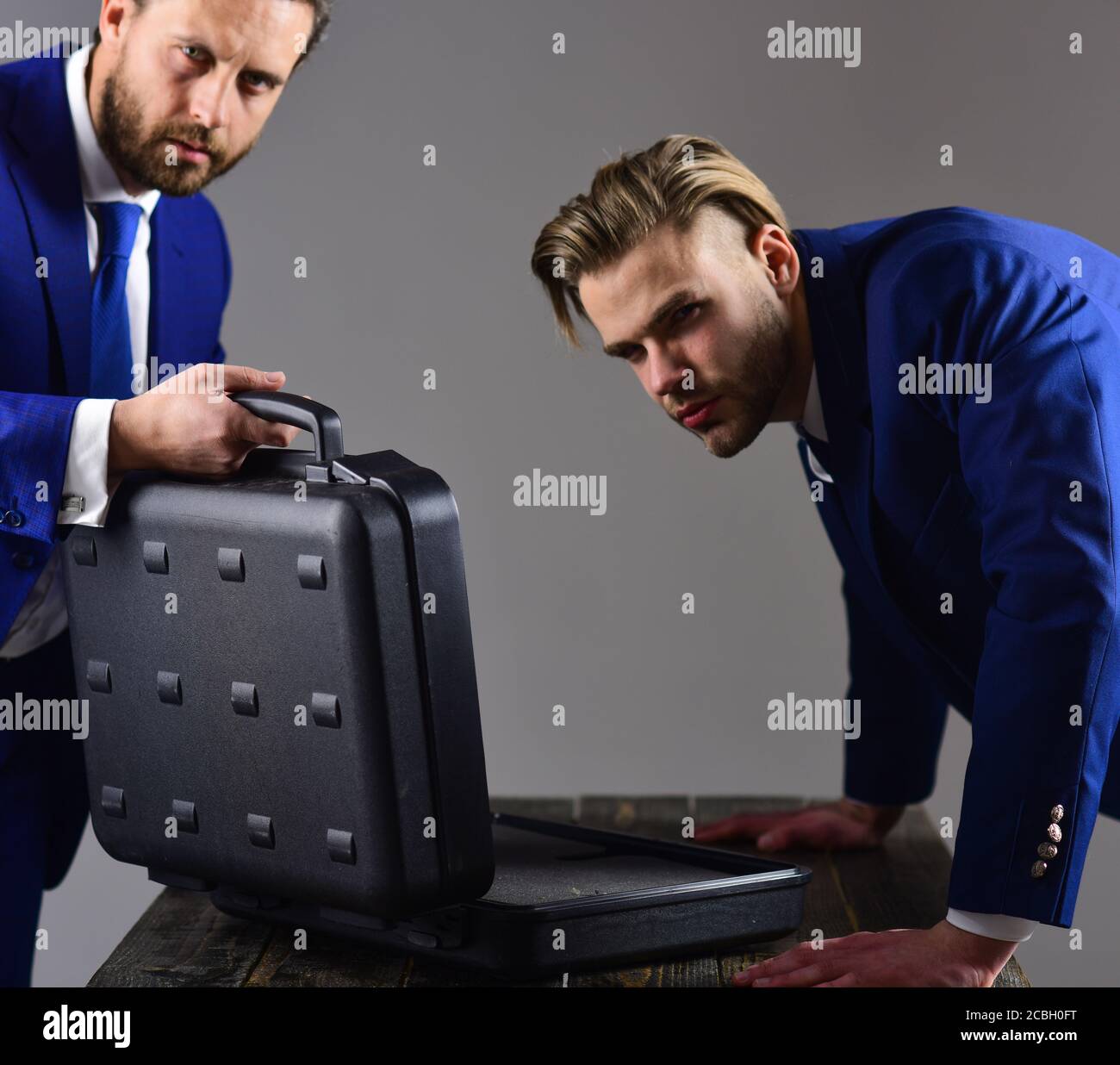 Business exchange concept. Handover of briefcase with illegal goods ...