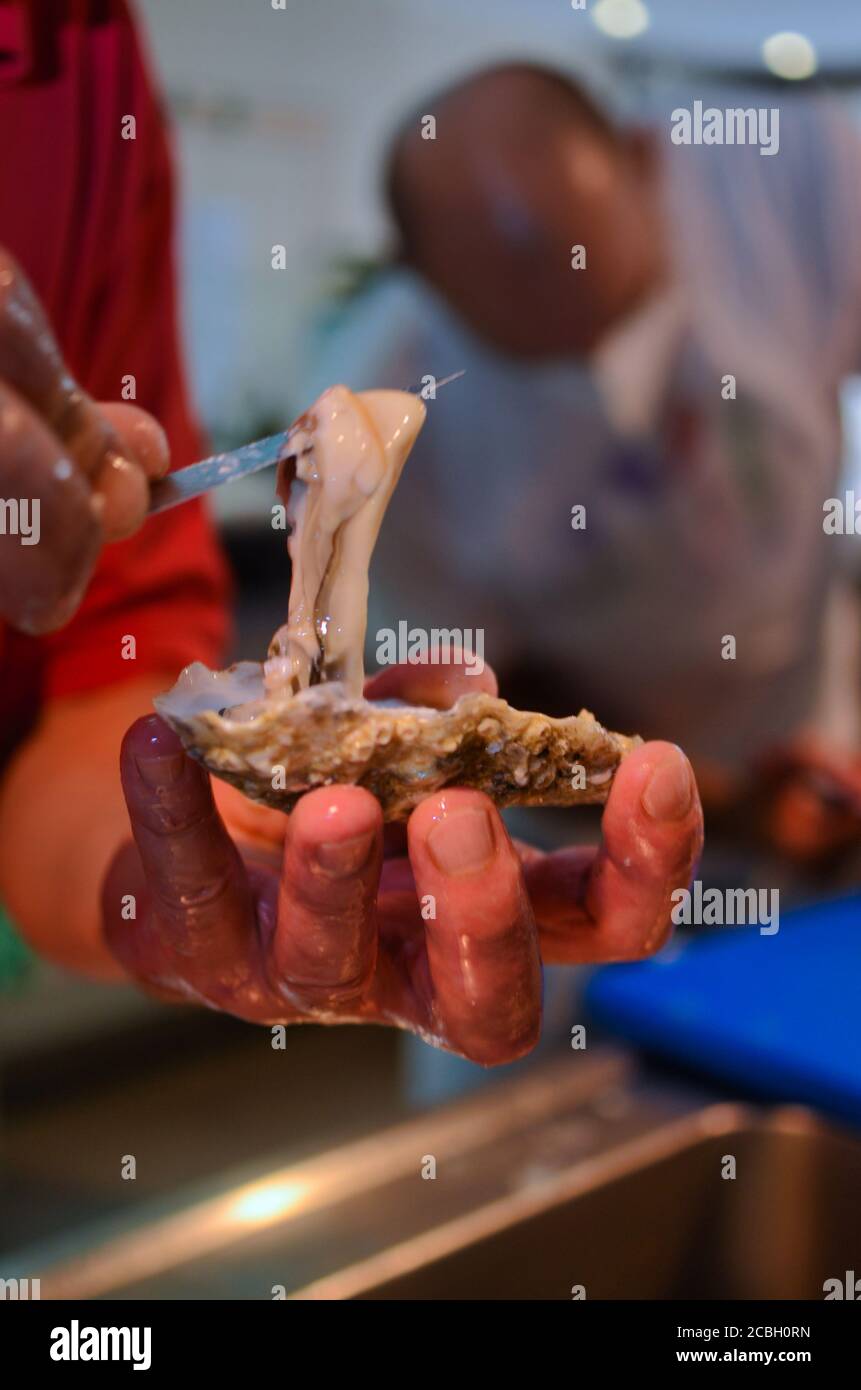 Italy - August 2020 at the fish market butcher works cleaning and ...