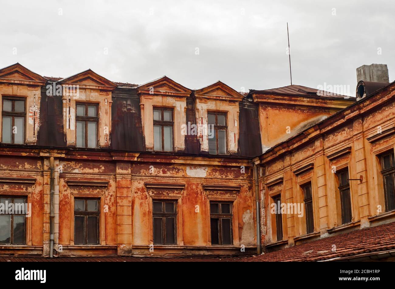 Old vintage dacayed neglected building facade closeup in cloudy day ...