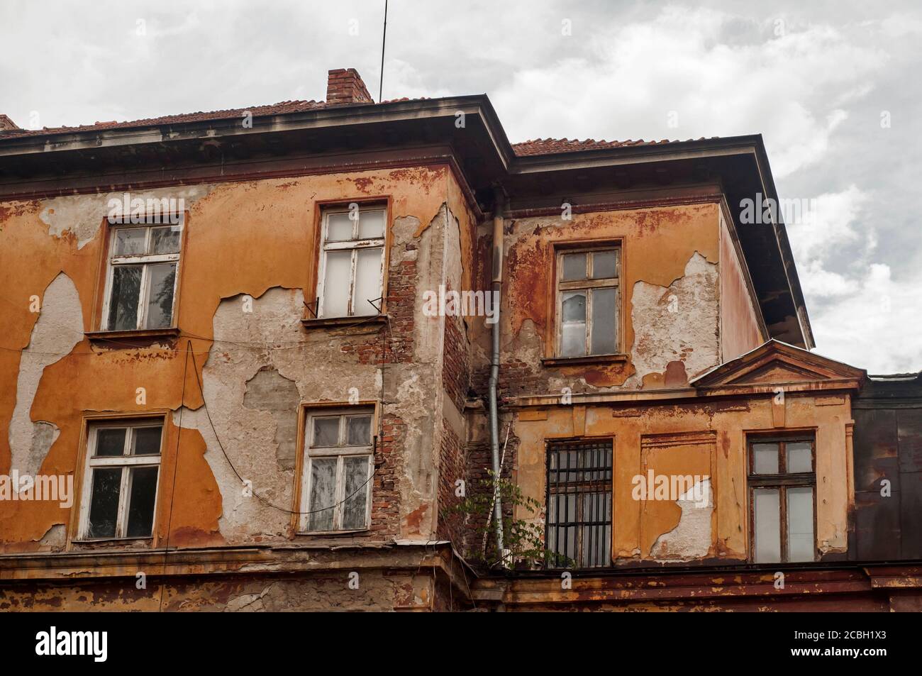 Old vintage dacayed neglected building facade closeup in cloudy day ...