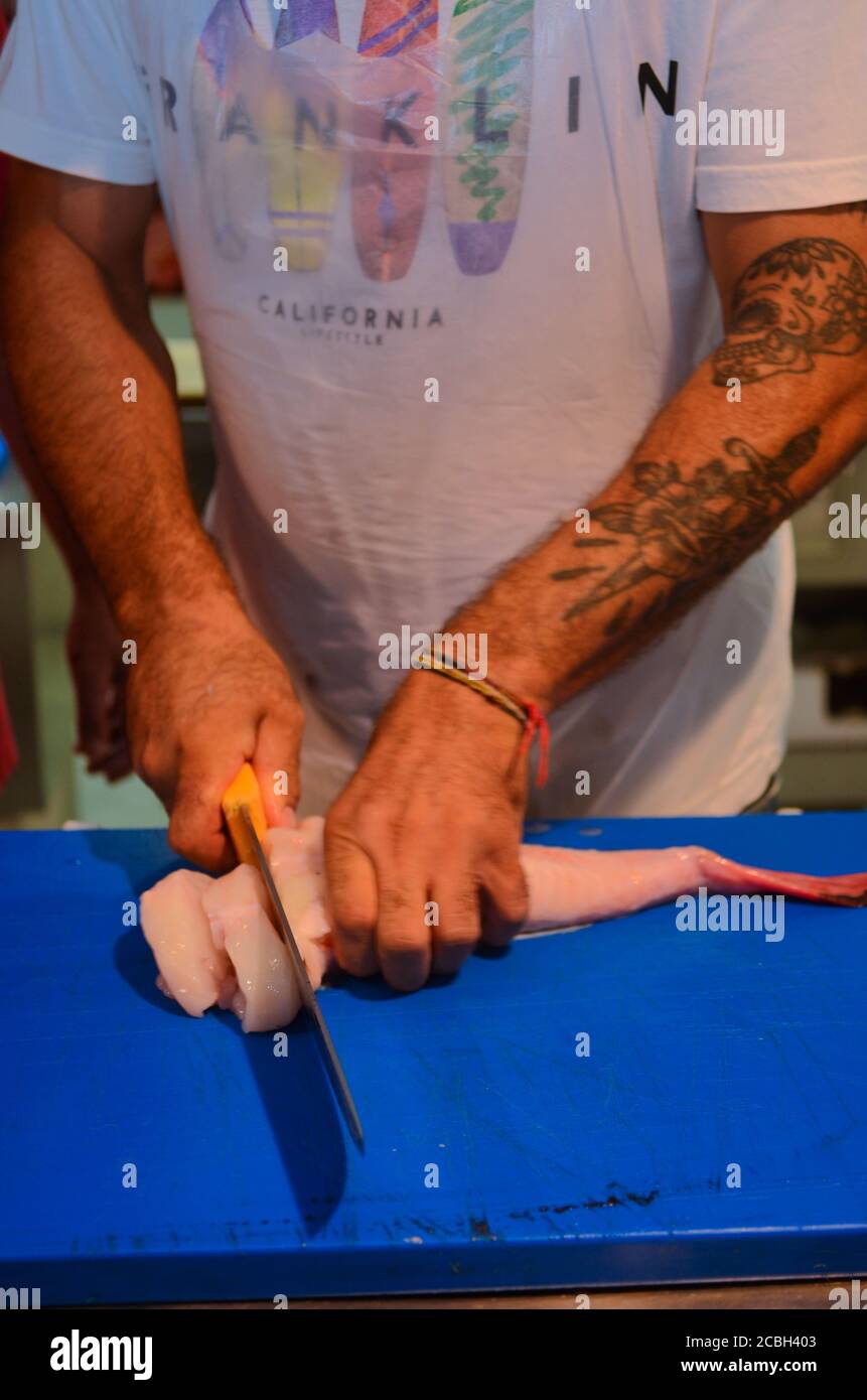 Italy - August 2020 at the fish market butcher works cleaning and ...