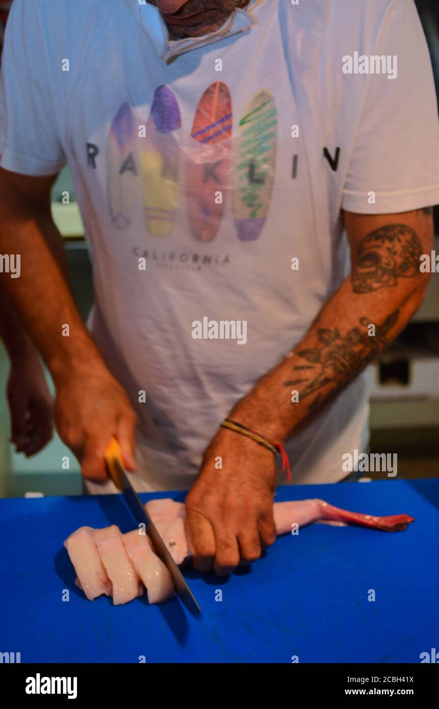 Italy - August 2020 at the fish market butcher works cleaning and ...