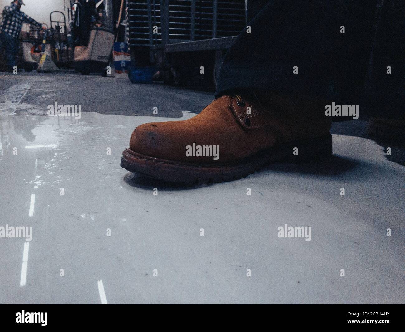 A Man Wearing a Leather Boot Stepping in Spilled Milk Stock Photo - Alamy